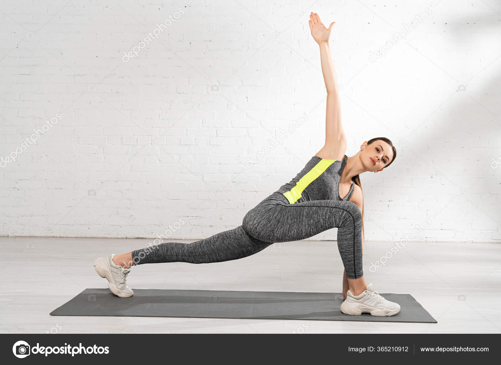 Attractive Sportswoman Outstretched Hand Exercising Fitness Mat Stock ...