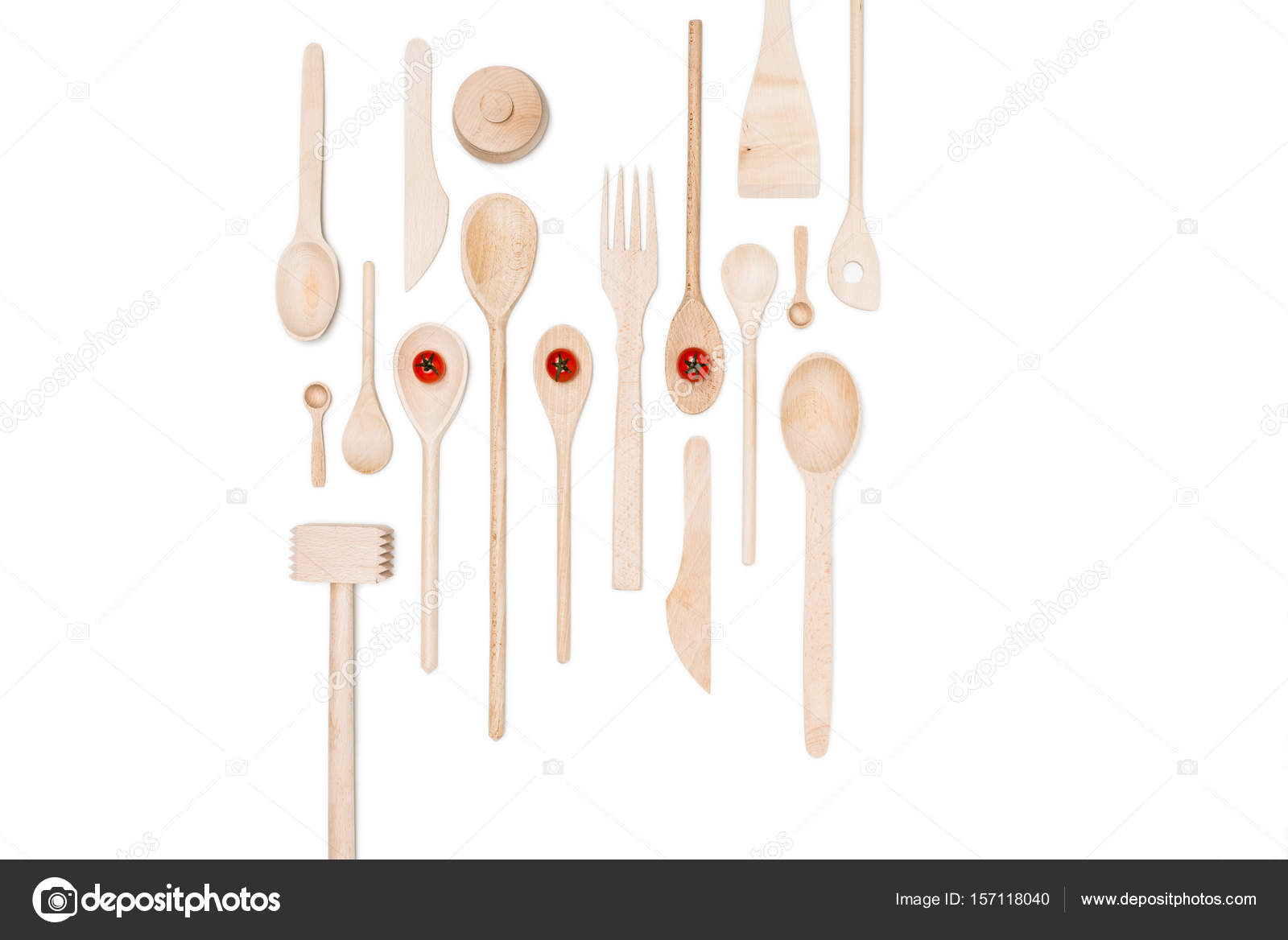 Top view of various wooden cooking utensils with cherry tomatoes ...