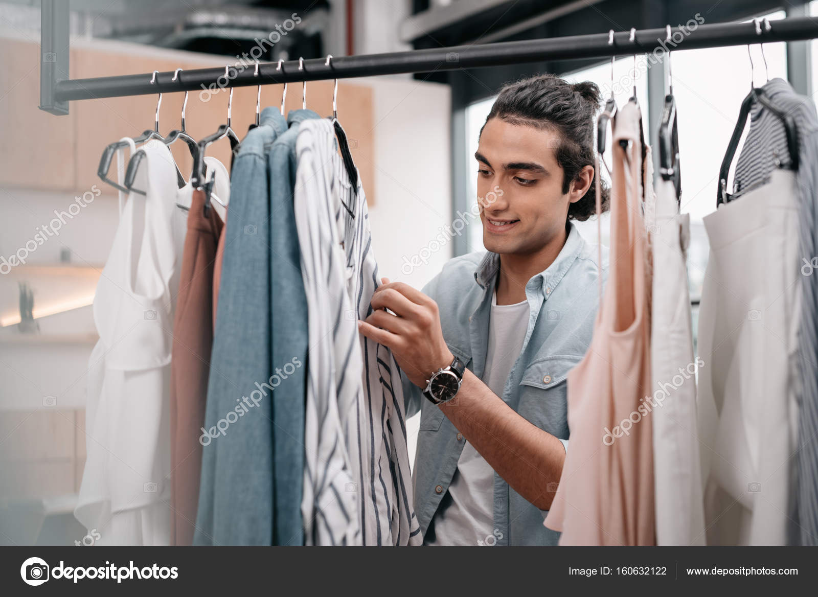 Hombre trabajando con ropa en boutique: fotografía de stock ...