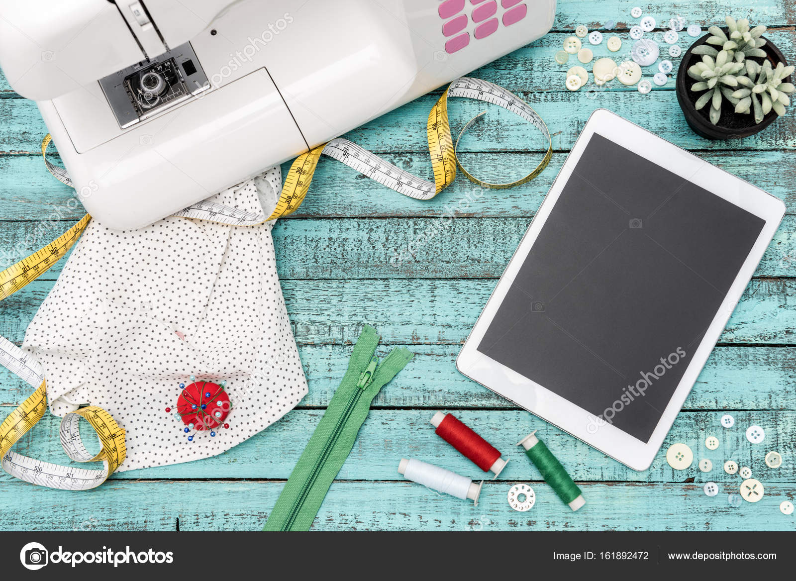 Digital tablet and tailoring items on table Stock Photo by ...