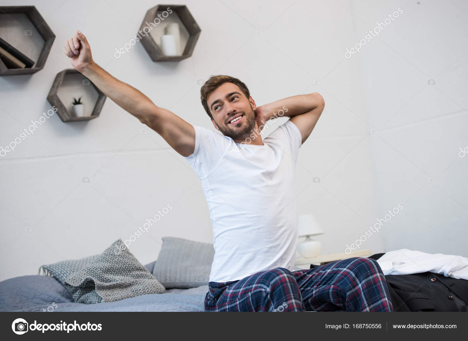 Images: image smiling guy | Smiling man stretching on bed — Stock Photo ...