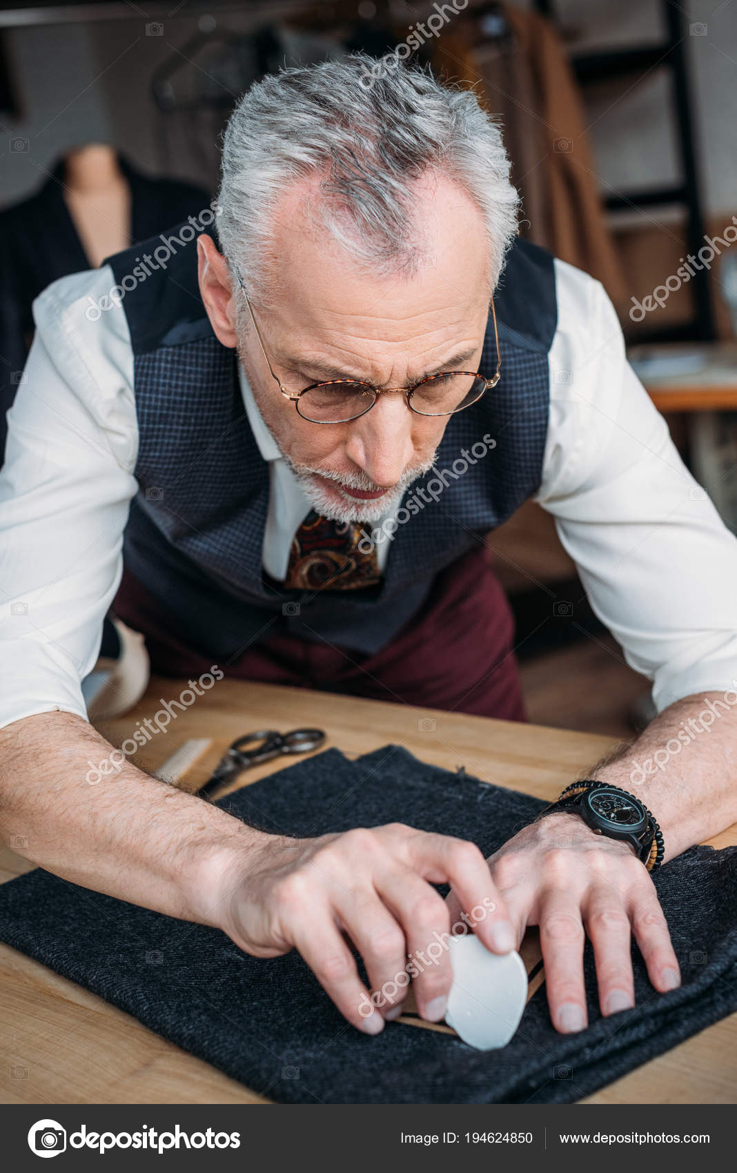 Focused Mature Tailor Marking Cloth Pattern Chalk Sewing Workshop ...