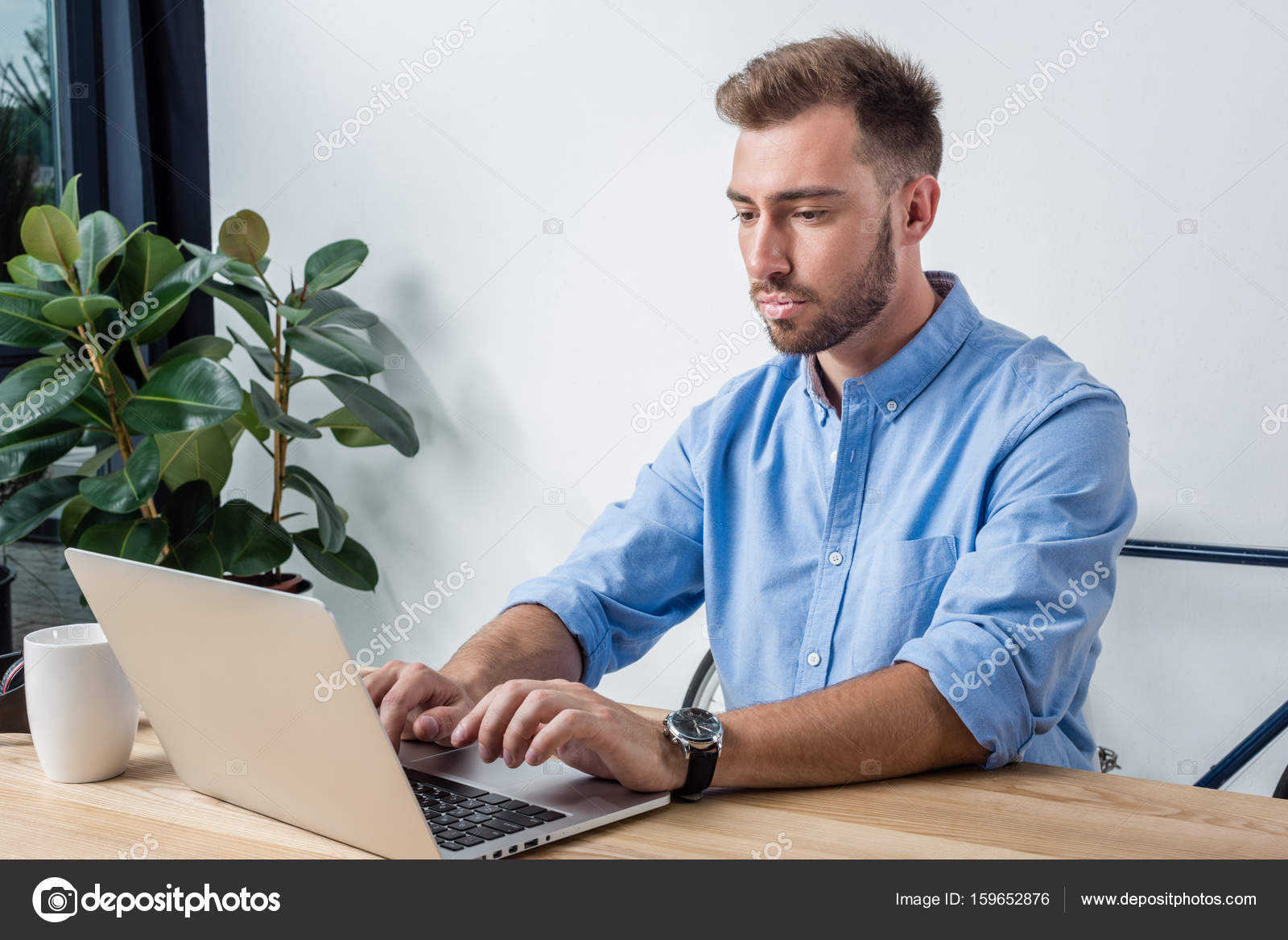 Businessman with laptop in office — Stock Photo © EdZbarzhyvetsky ...