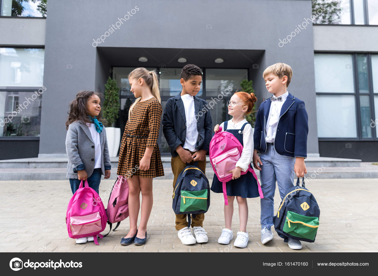 Multiethnic kids near school — Stock Photo © EdZbarzhyvetsky #161470160