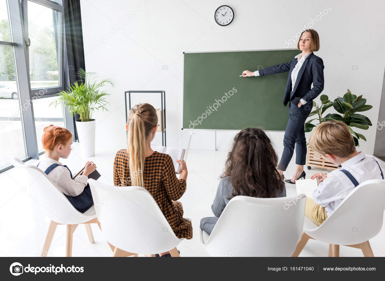 Teacher explaining lesson to students Stock Photo by ©EdZbarzhyvetsky ...