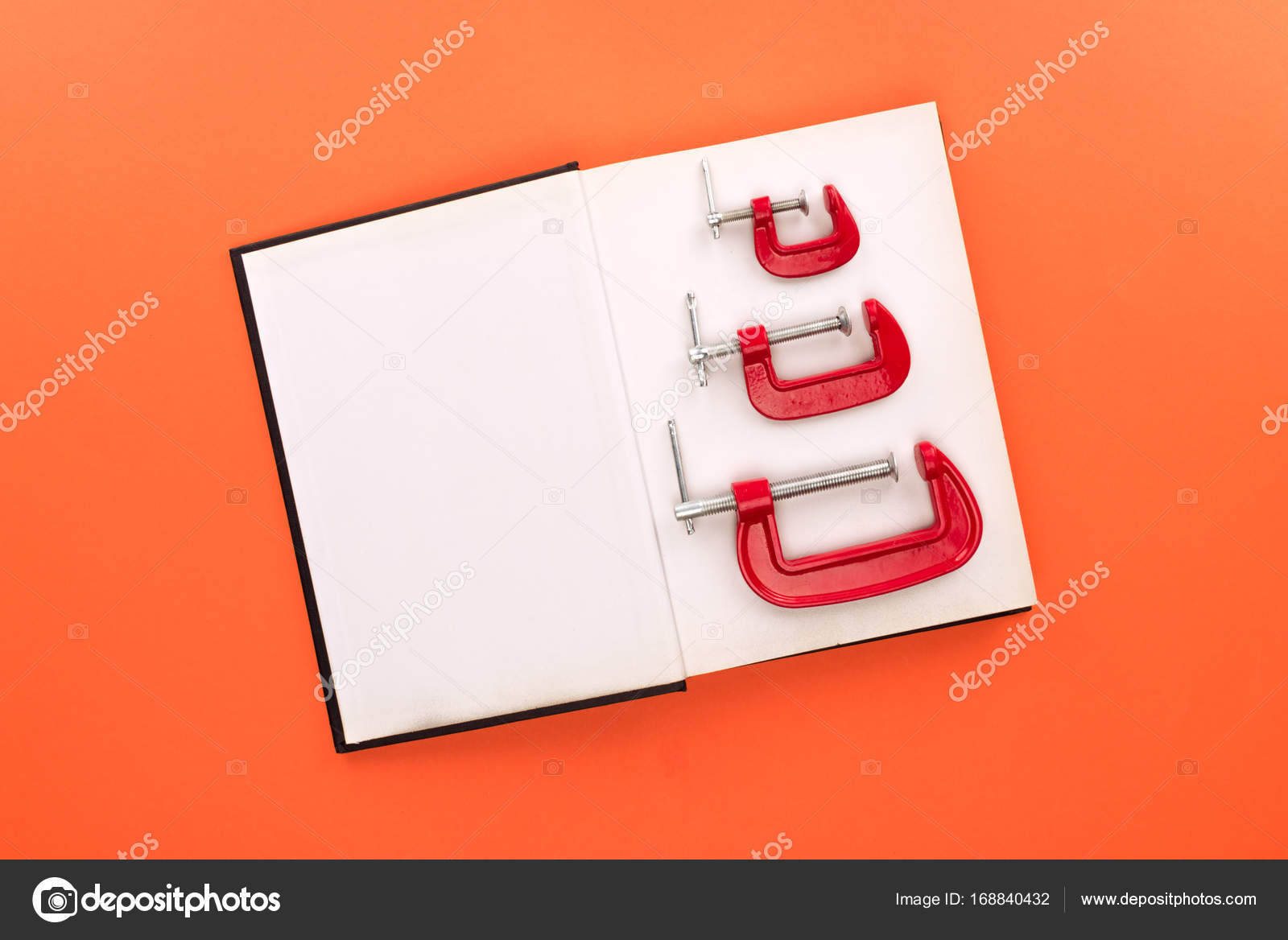 Open notebook and c-clamps — Free Stock Photo © EdZbarzhyvetsky #168840432