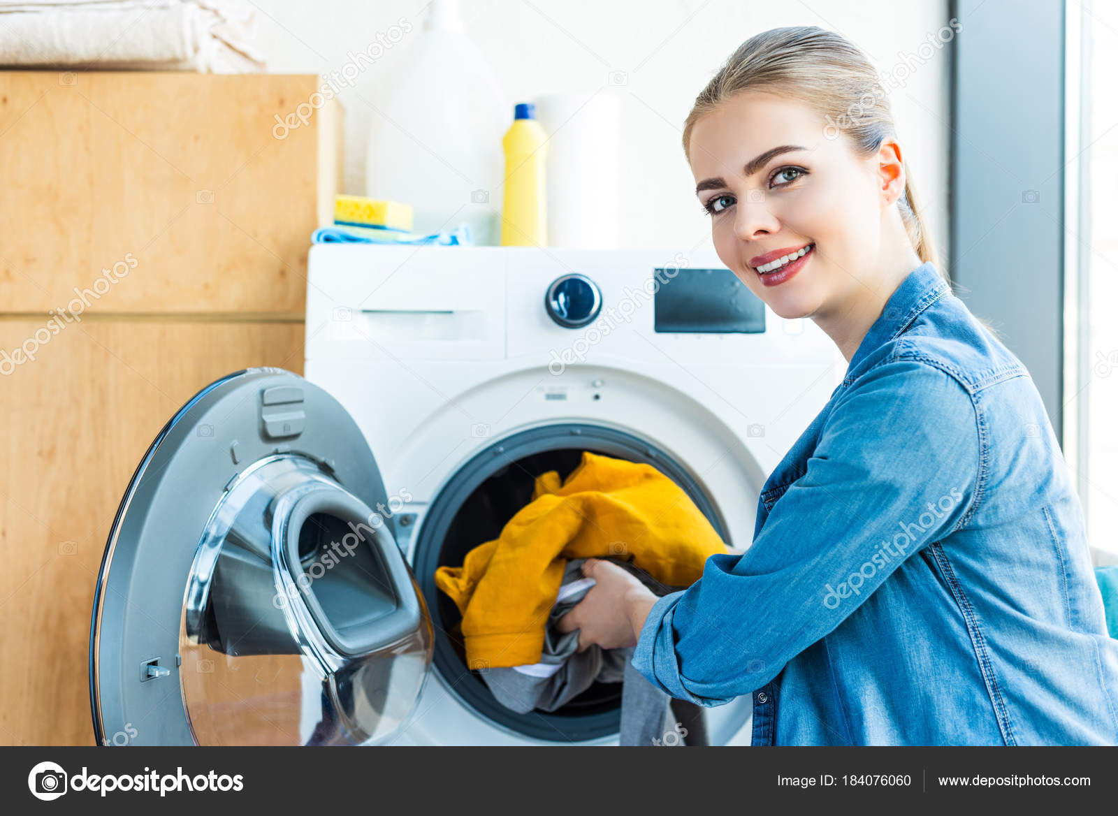 Young Woman Smiling Camera While Putting Laundry Washing Machine ...