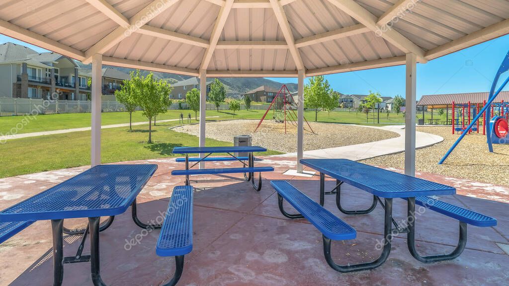 Marco panor mico Mesa de picnic azul y asientos dentro de un pabell n con forma de oct gono en ...