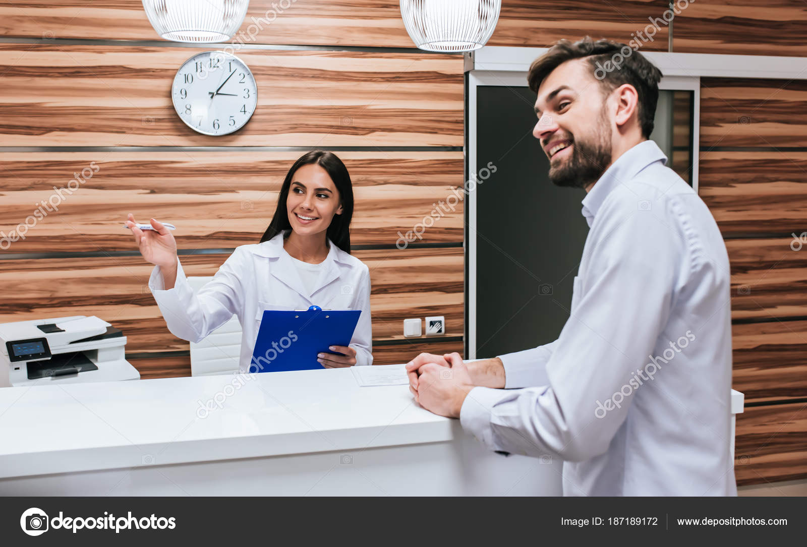 Receptionist in modern clinic Stock Photo by ©4pmphoto@gmail.com 187189172