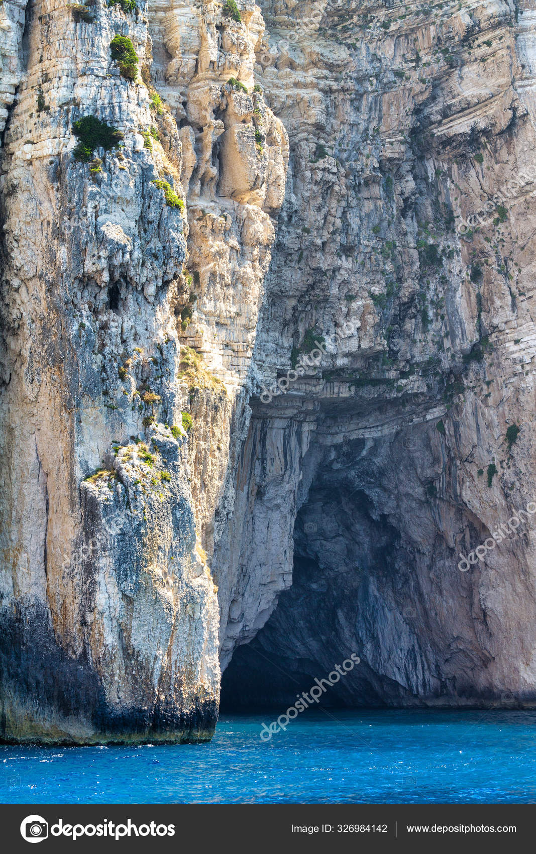 Steep cliffs with sea caves on the coast of the Paxos island. — Stock ...