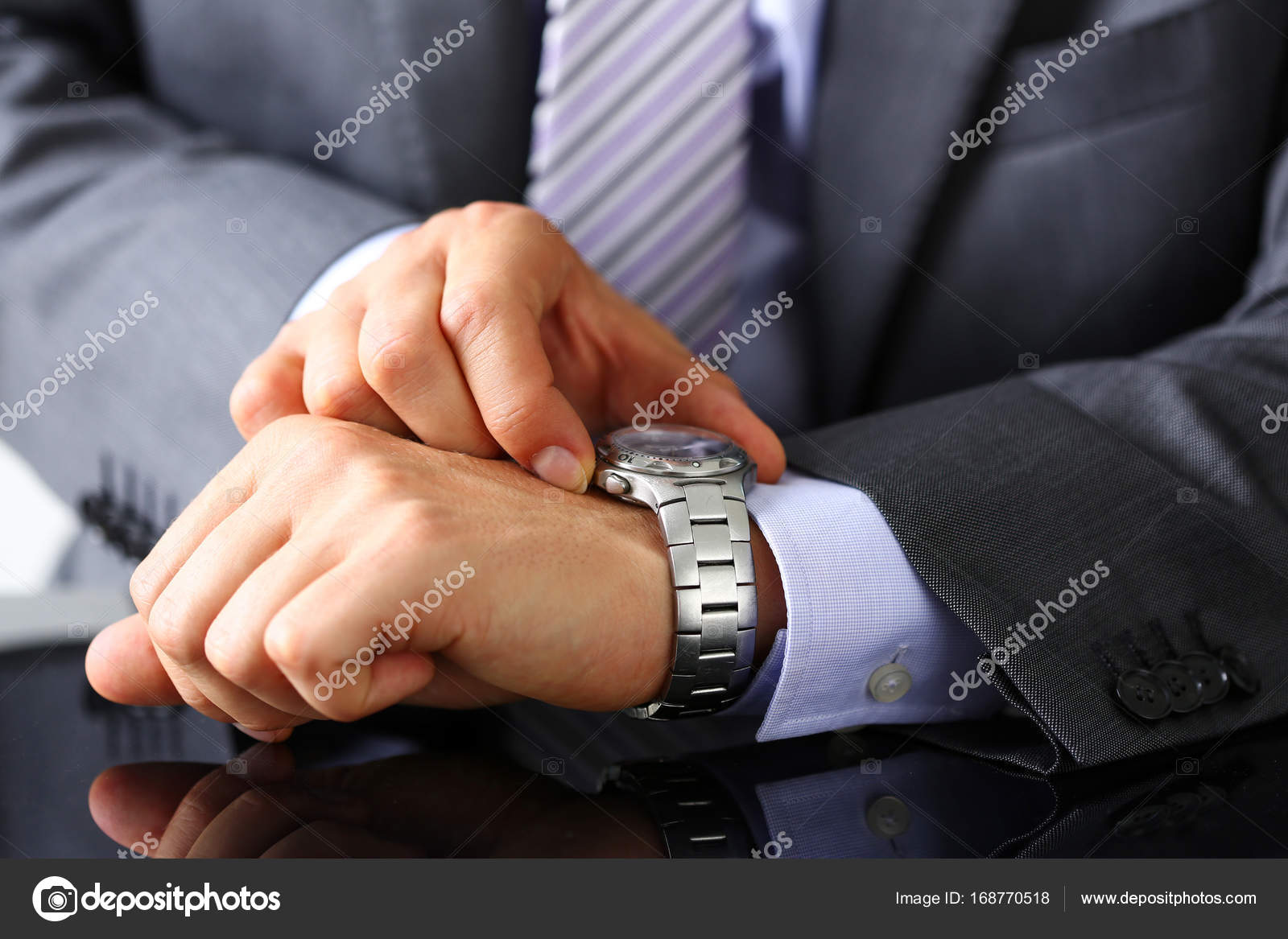 Man in suit and tie check out time at silver wristwatch ⬇ Stock Photo ...