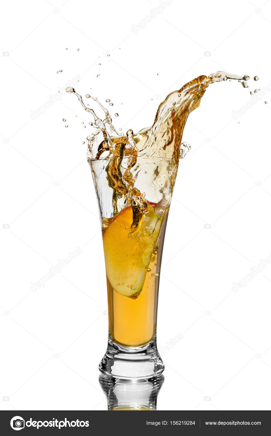 A piece of Apple falling into a glass of juice Stock Photo by ...