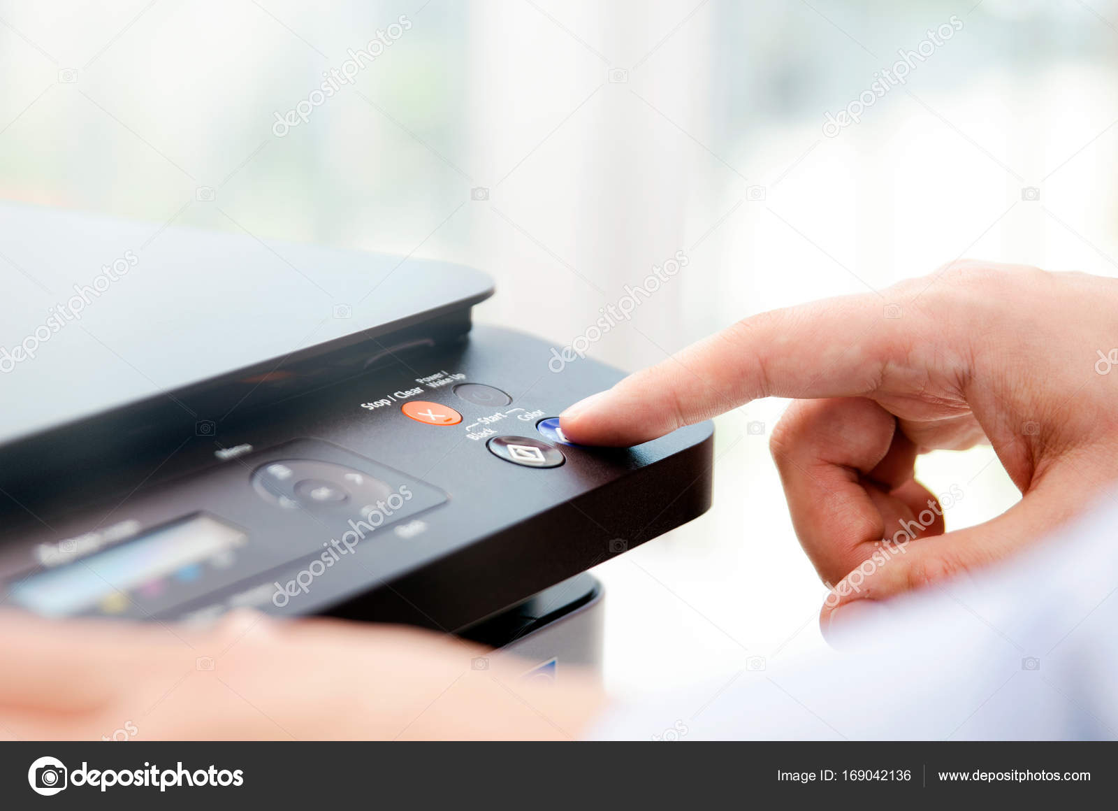 Hand press button on panel of printer Stock Photo by ©simpson33 169042136