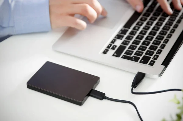 External backup disk hard drive connected to laptop Stock Photo by ...