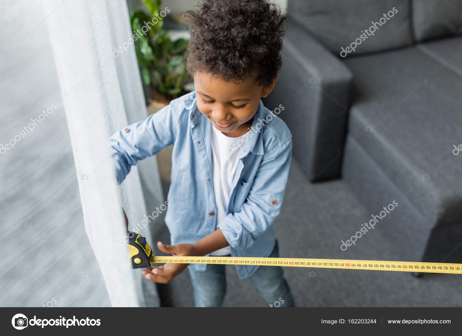 Adorable afro boy with measuring tape — Stock Photo © SarkisSeysian ...