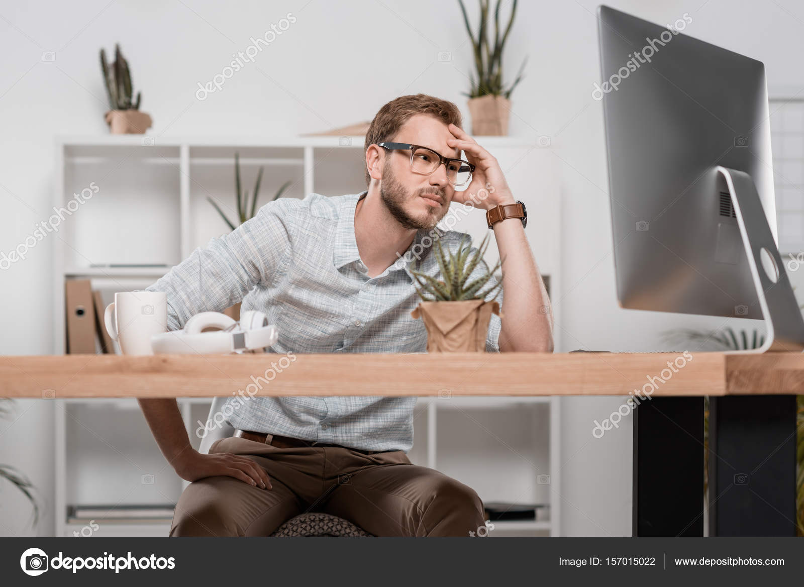 Businessman looking at computer — Stock Photo © AntonLozovoy #157015022