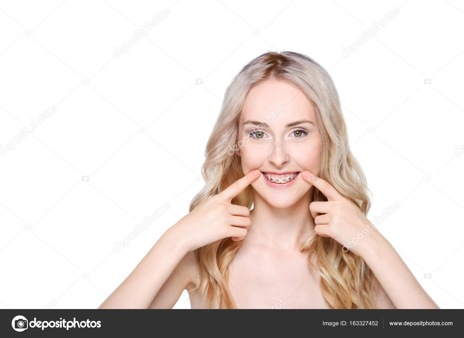 Woman pointing to teeth with braces — Stock Photo © AndrewLozovyi ...