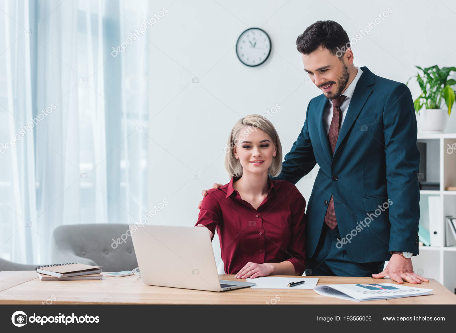 Smiling Young Business Colleagues Looking Laptop While Working Together ... Smiling Young Business Colleagues Looking Laptop While Working Together ...
