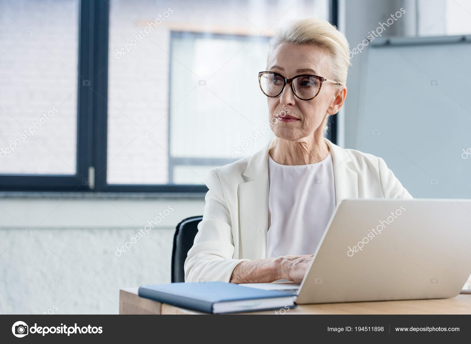 Serious Senior Businesswoman Eyeglasses Using Laptop Looking Away