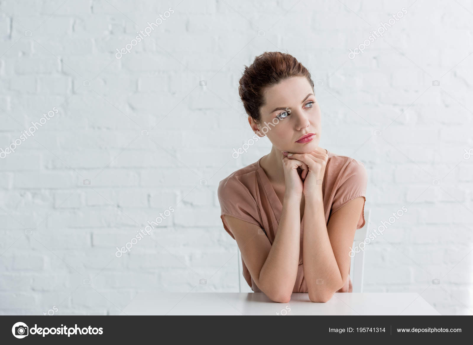 Thoughtful Young Woman Sitting Table Front White Brick Wall — Stock ...