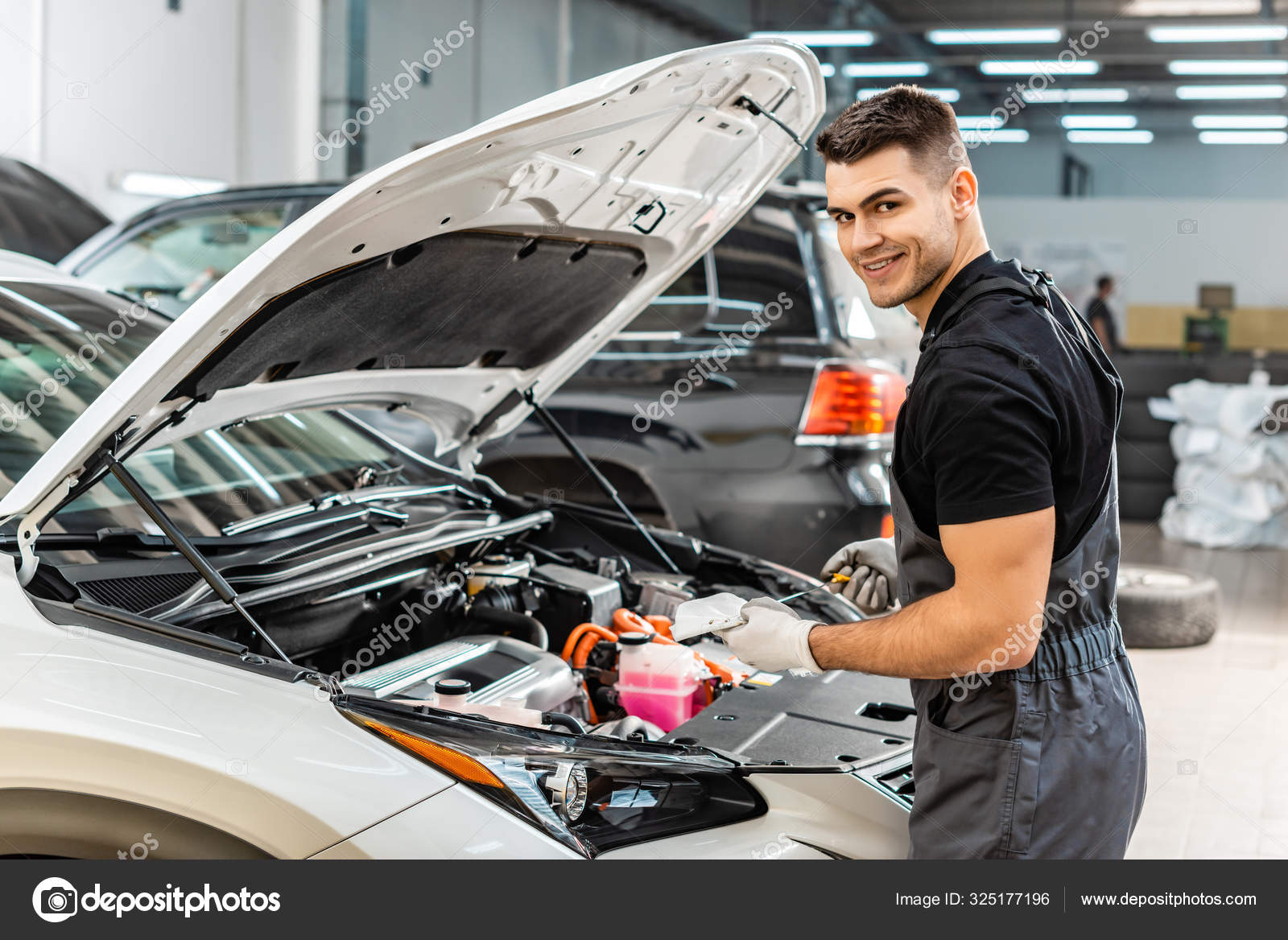 Handsome Mechanic Holding Oil Dipstick Smiling Camera Stock Photo by ...