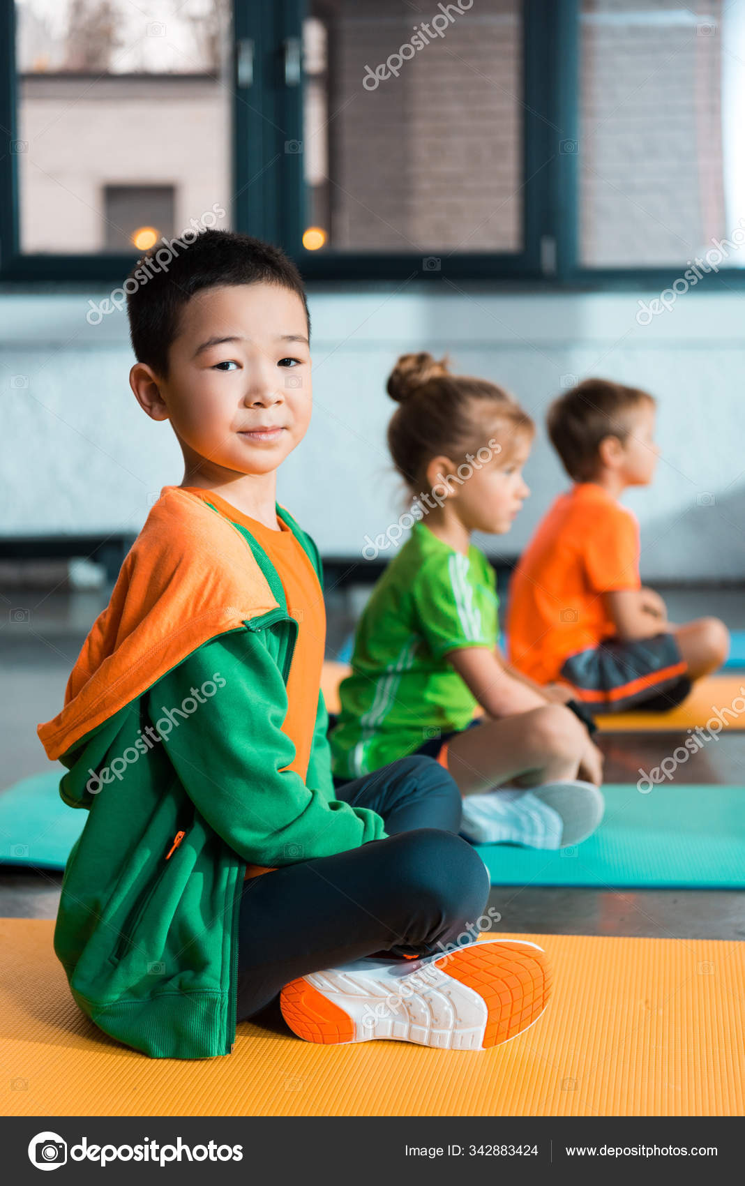 Selective Focus Multicultural Kids Crossed Legs Sitting Fitness Mats ...