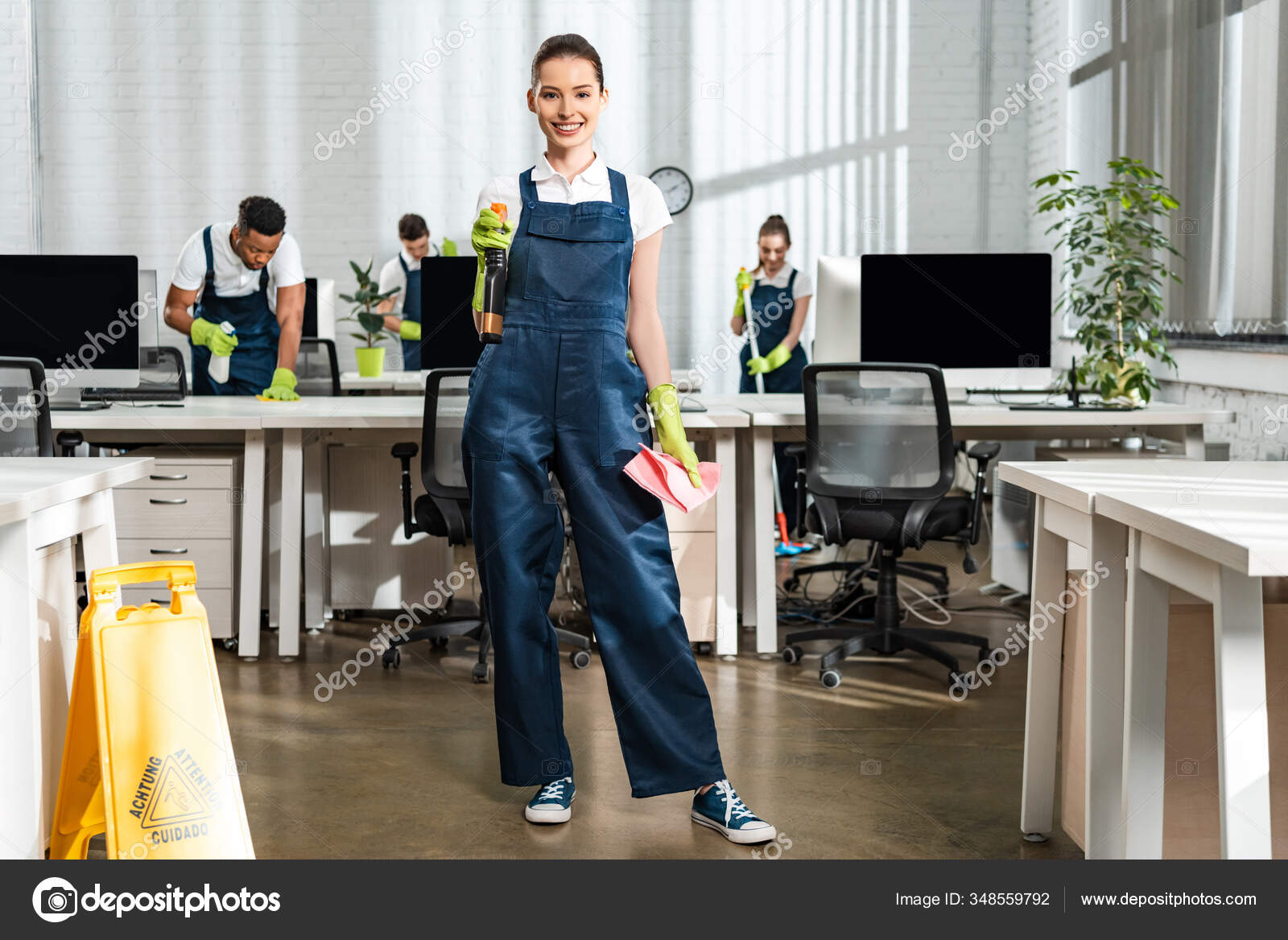 Smiling Cleaner Holding Spray Rag While Standing Working Multicultural ...