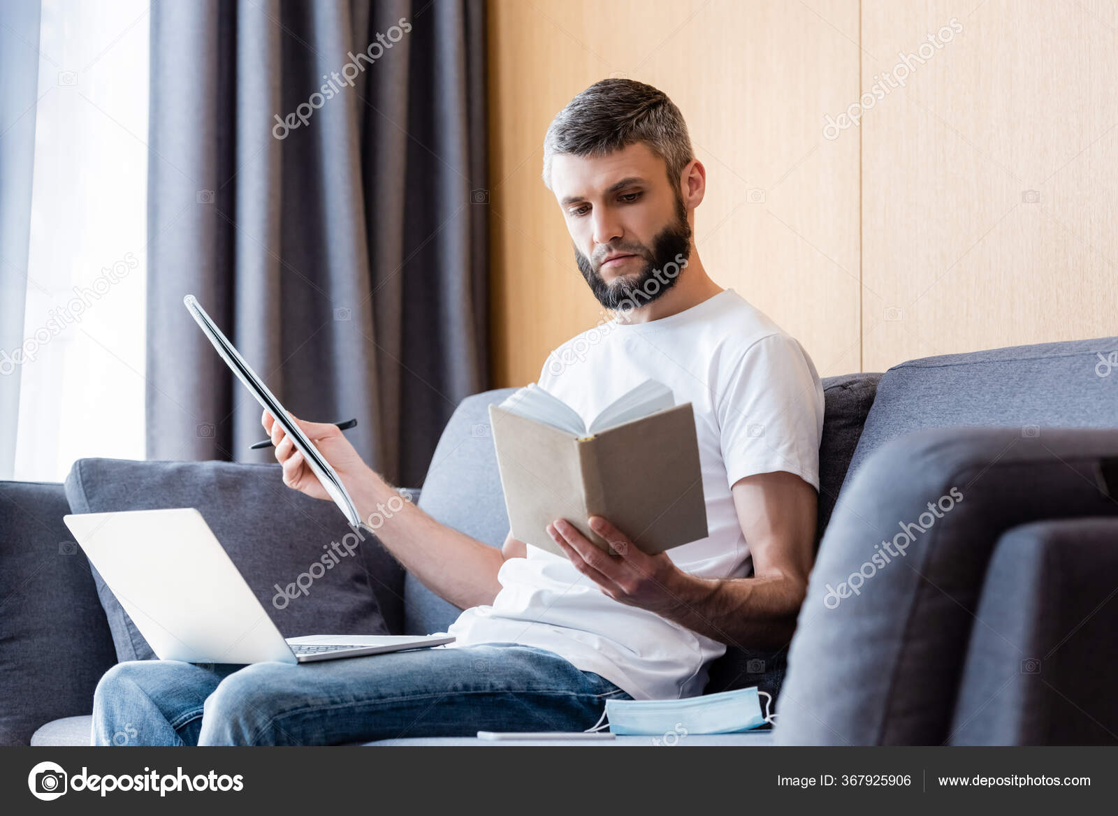 Selective Focus Teleworker Reading Book While Working Laptop Notebook ...