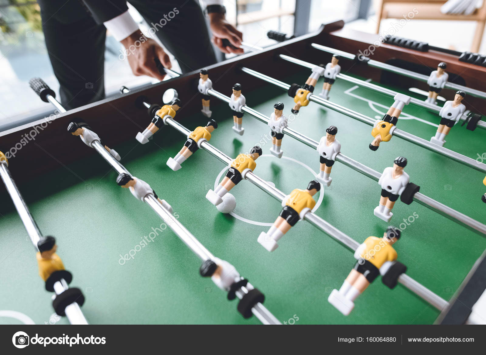 Businessman playing table football Stock Photo by ©EugeneGensyurovksy ...