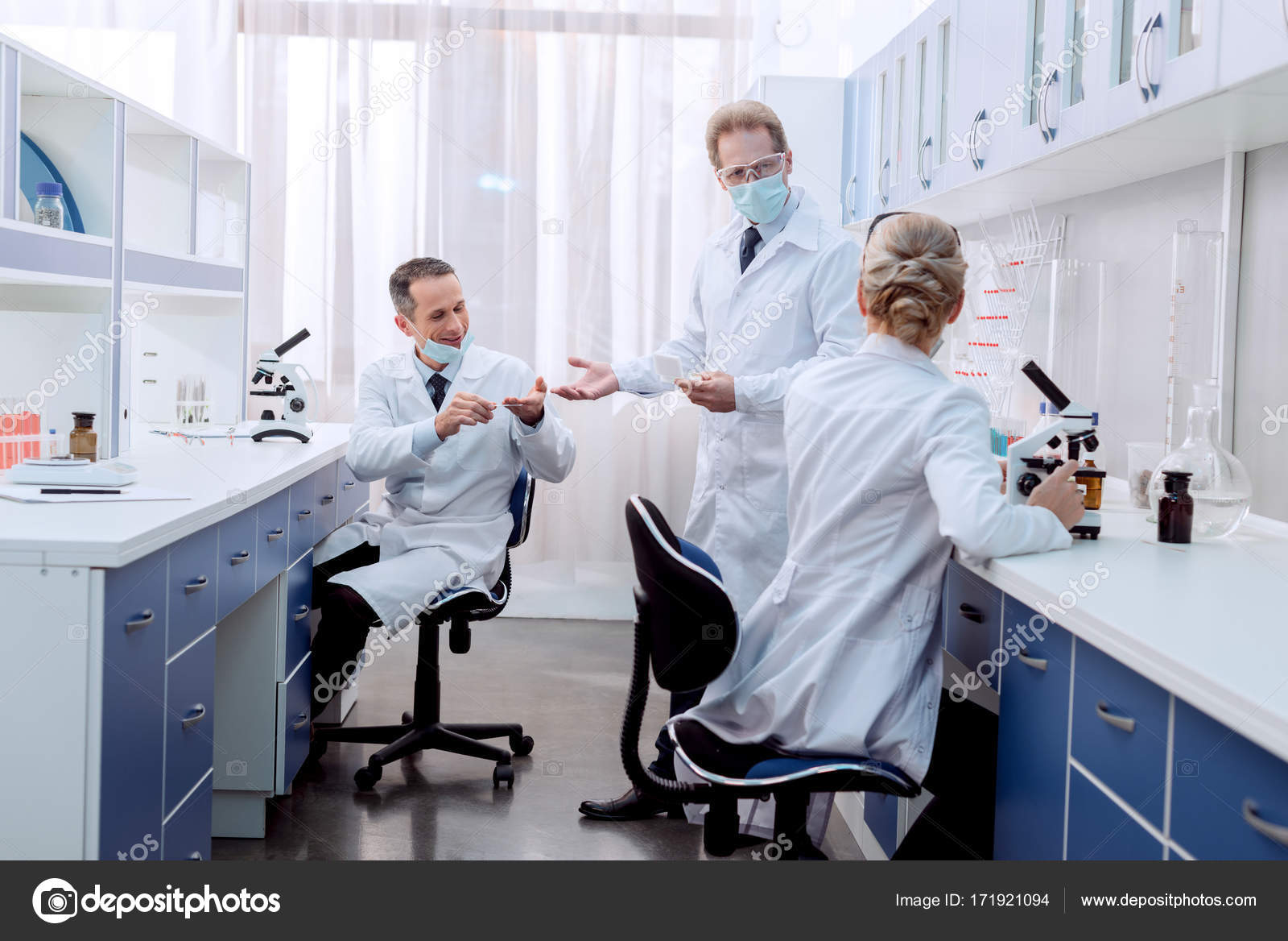 Medical workers talking in laboratory — Stock Photo © VitalikRadko ...