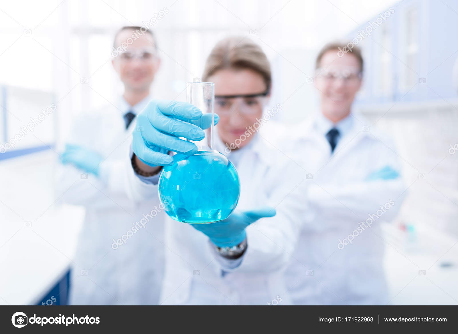 Doctor showing flask with reagent — Stock Photo © VitalikRadko #171922968