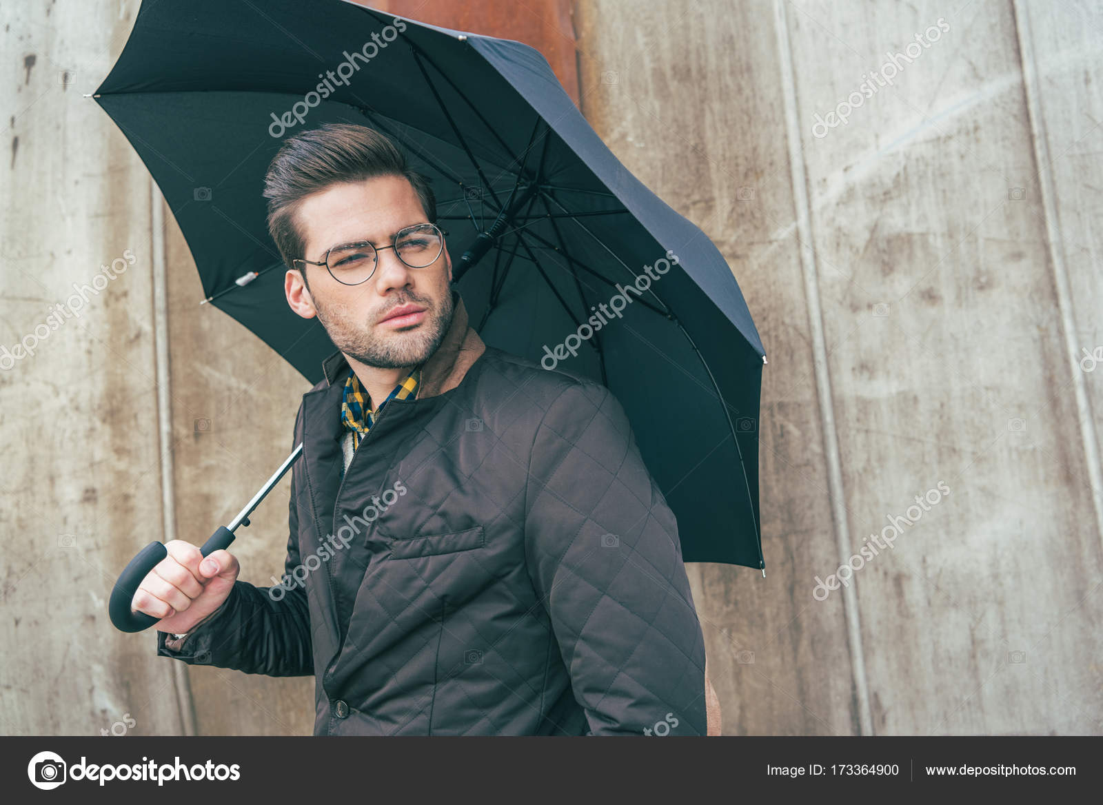 Young man with umbrella — Stock Photo © VitalikRadko #173364900