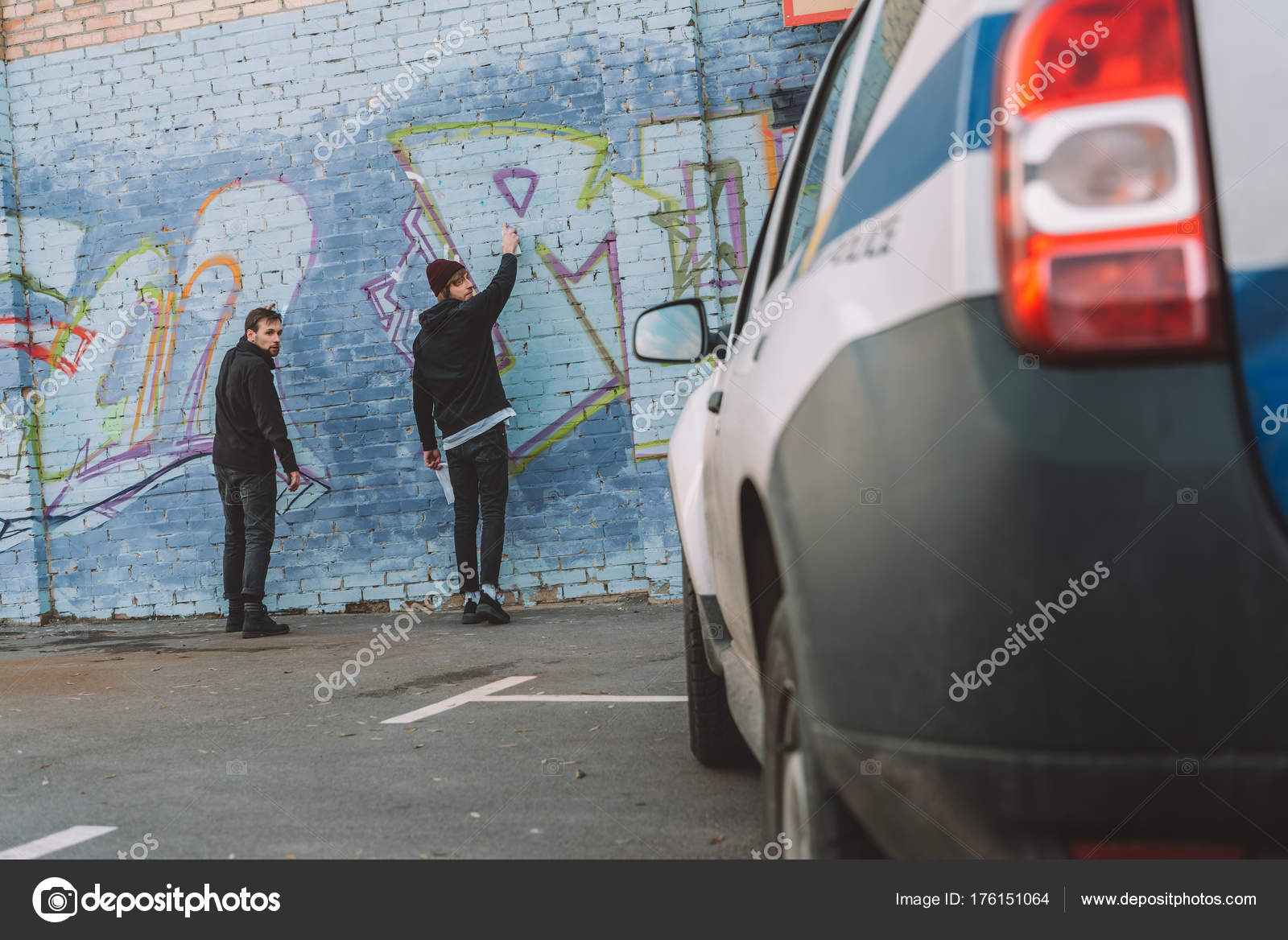 Back View Vandals Painting Graffiti Wall Police Car Foreground Stock ...