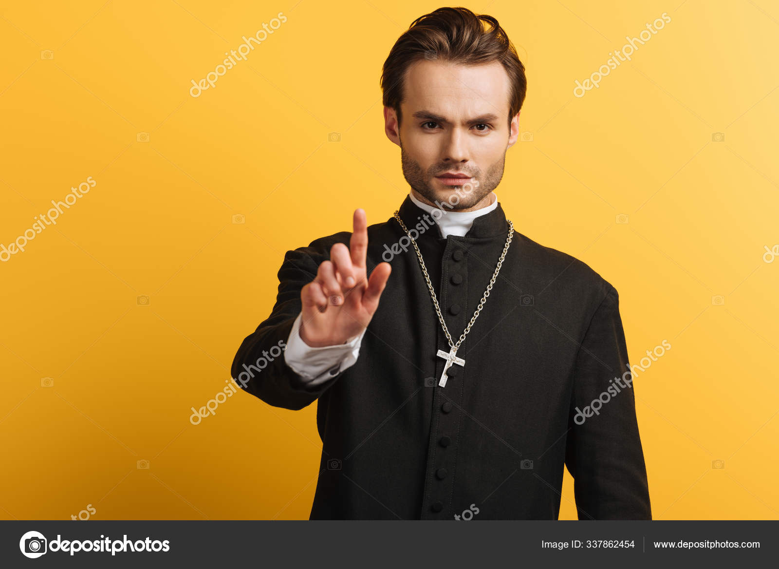 Serious Catholic Priest Showing Warning Gesture Isolated Yellow — Stock ...