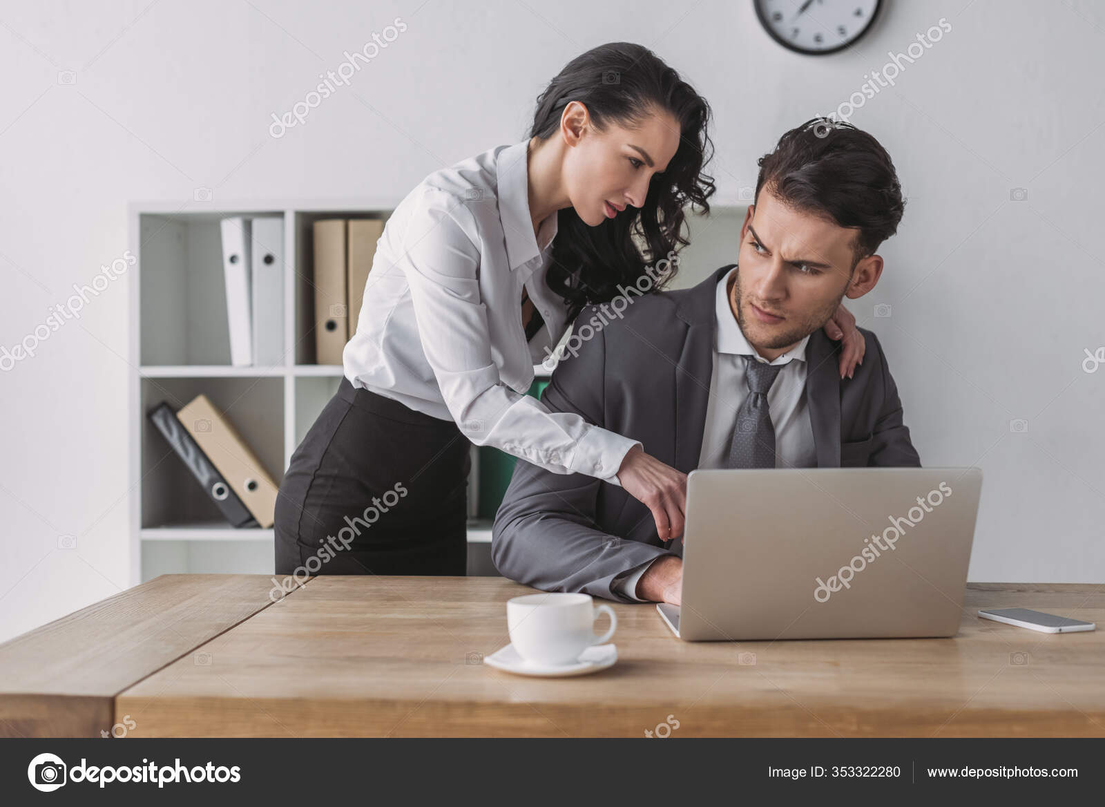 Sexy Secretary Touching Shoulder Serious Businessman While Pointing