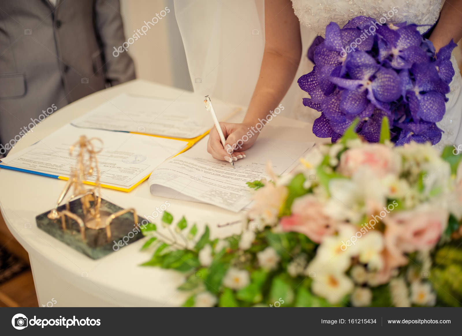 Signature Ceremony. The bride and groom sign the documents about the ...
