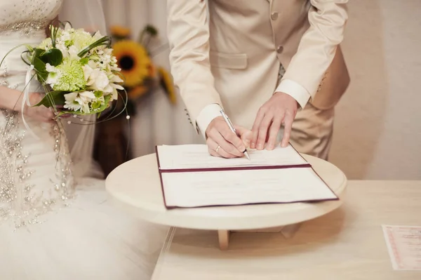 Signature Ceremony. The bride and groom sign the documents about the ...