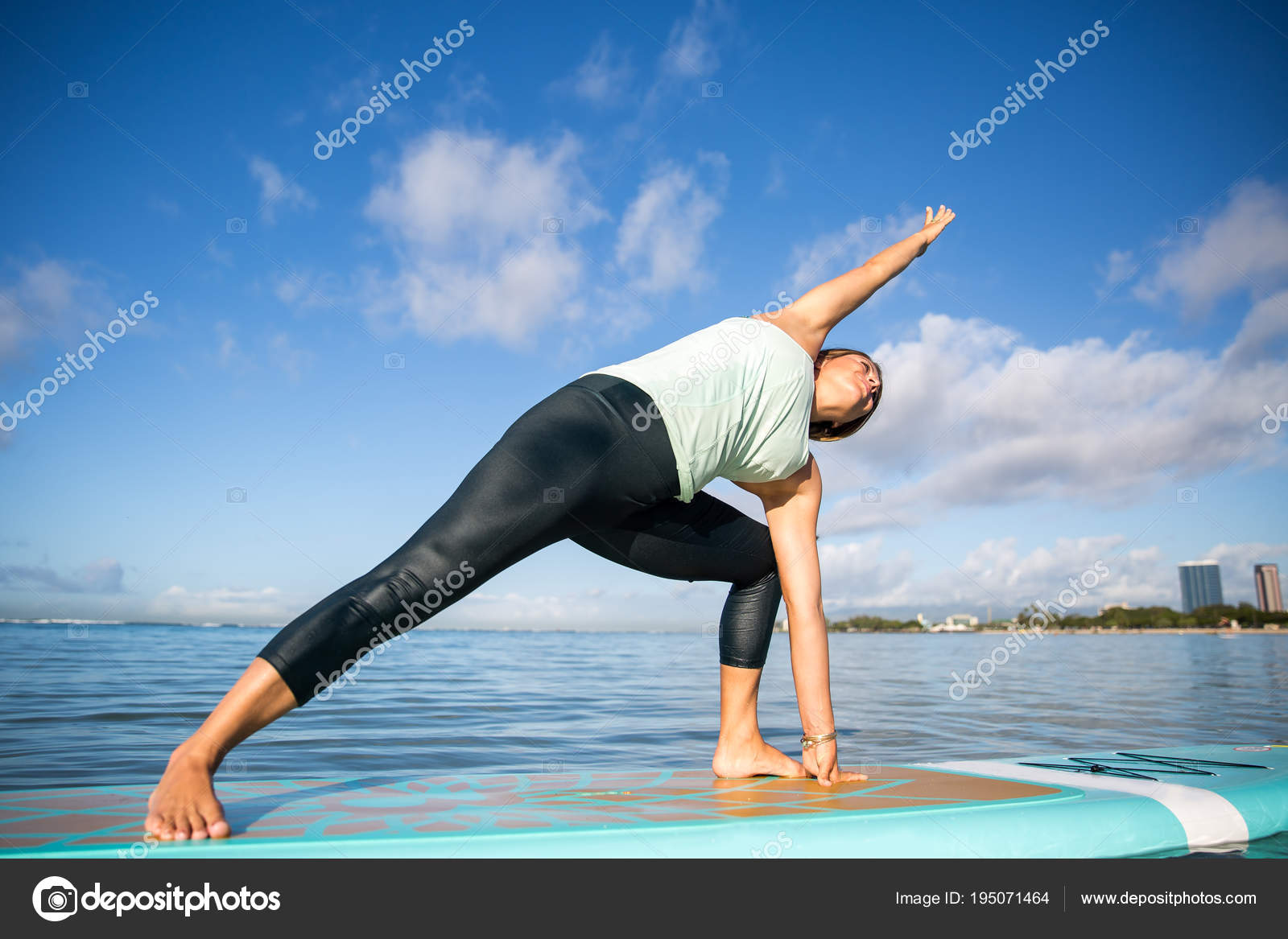 Athletic young woman in SUP Yoga practice side bend Pose in Ala Stock ...