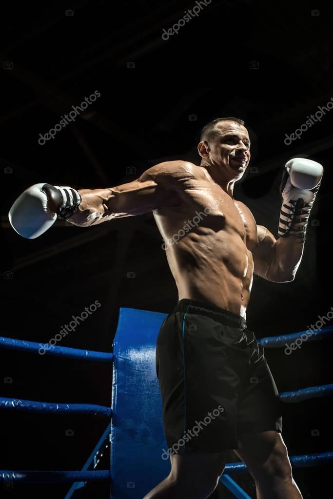 Punching boxer on boxing ring Stock Photo by ©tankist276 129099930