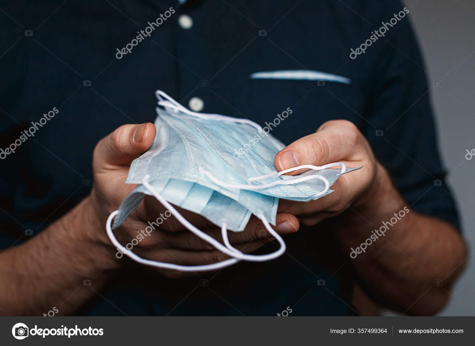Medical masks made of cotton in mens hands. The concept of protection ...