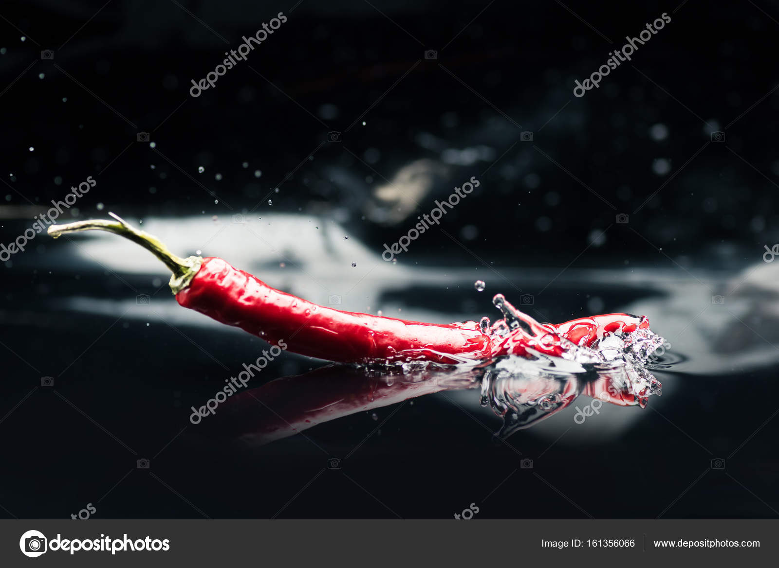 Chili pepper falling in water Stock Photo by ©VadimVasenin 161356066