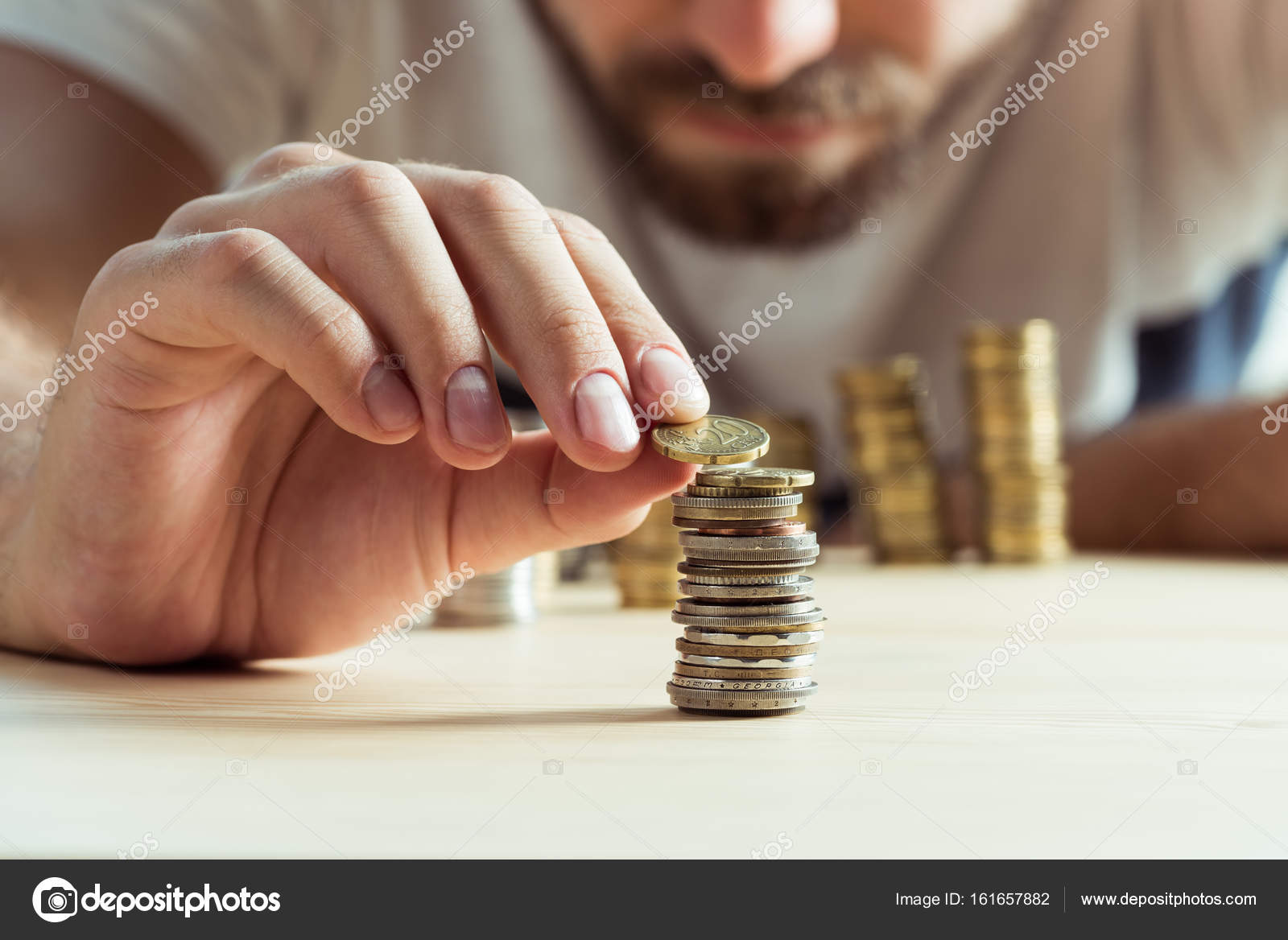 Man stacking coins — Stock Photo © VadimVasenin #161657882