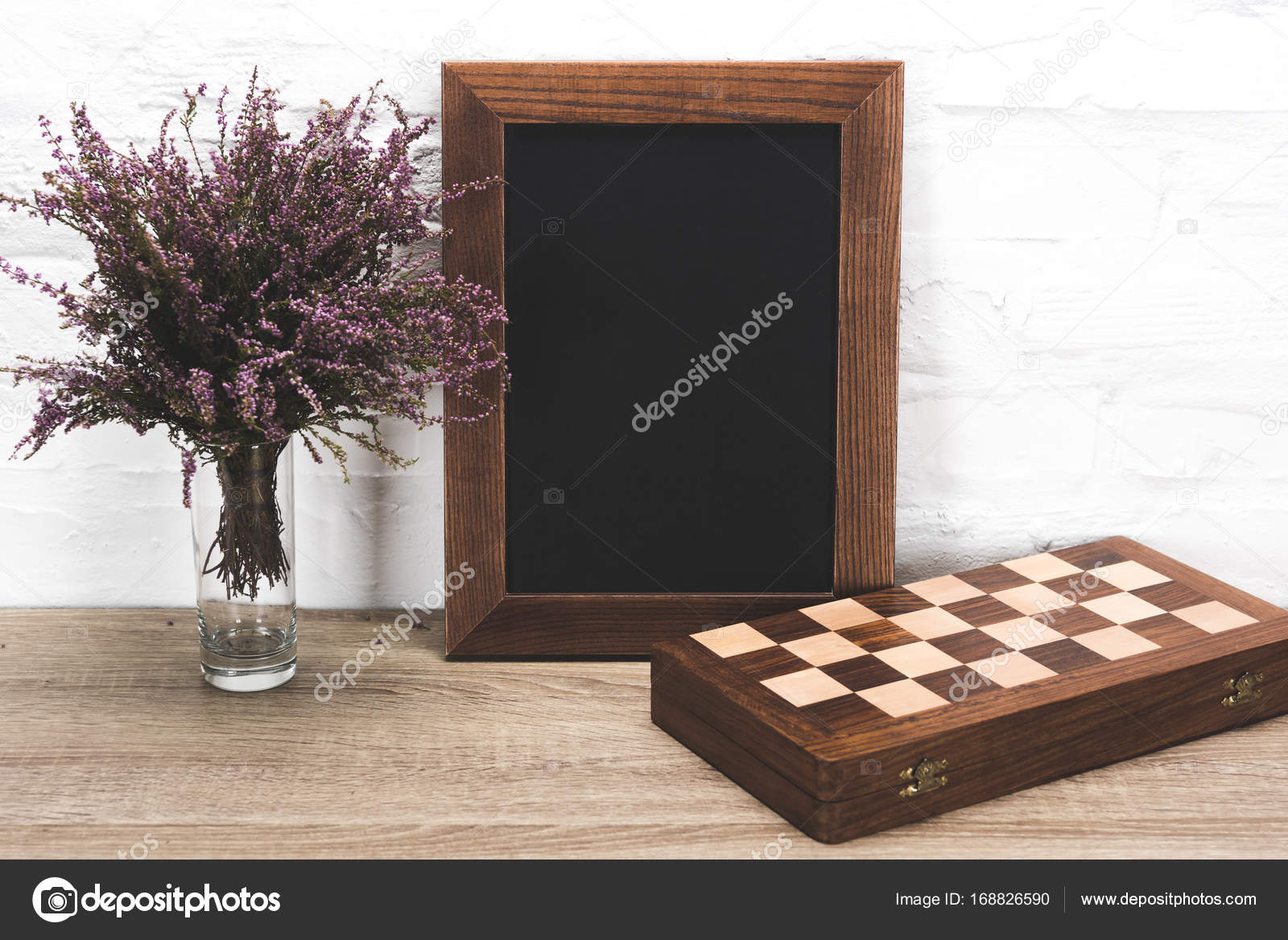 Photo frame and chess board on table Stock Photo by ©VadimVasenin 168826590