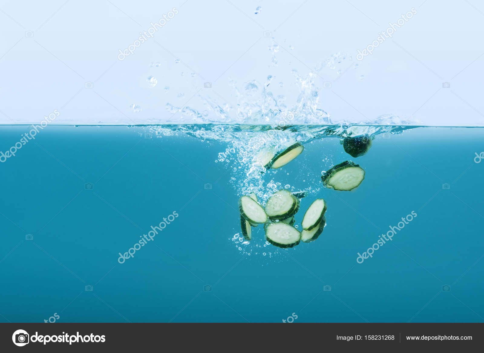 Cucumber slices falling into water with splashes — Stock Photo ...