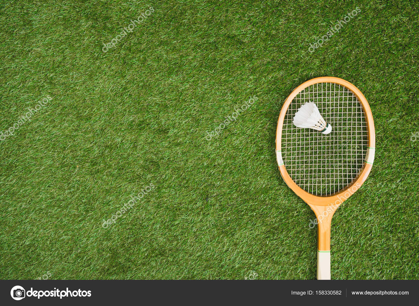 Badminton racket with shuttlecock on grass — Stock Photo ...