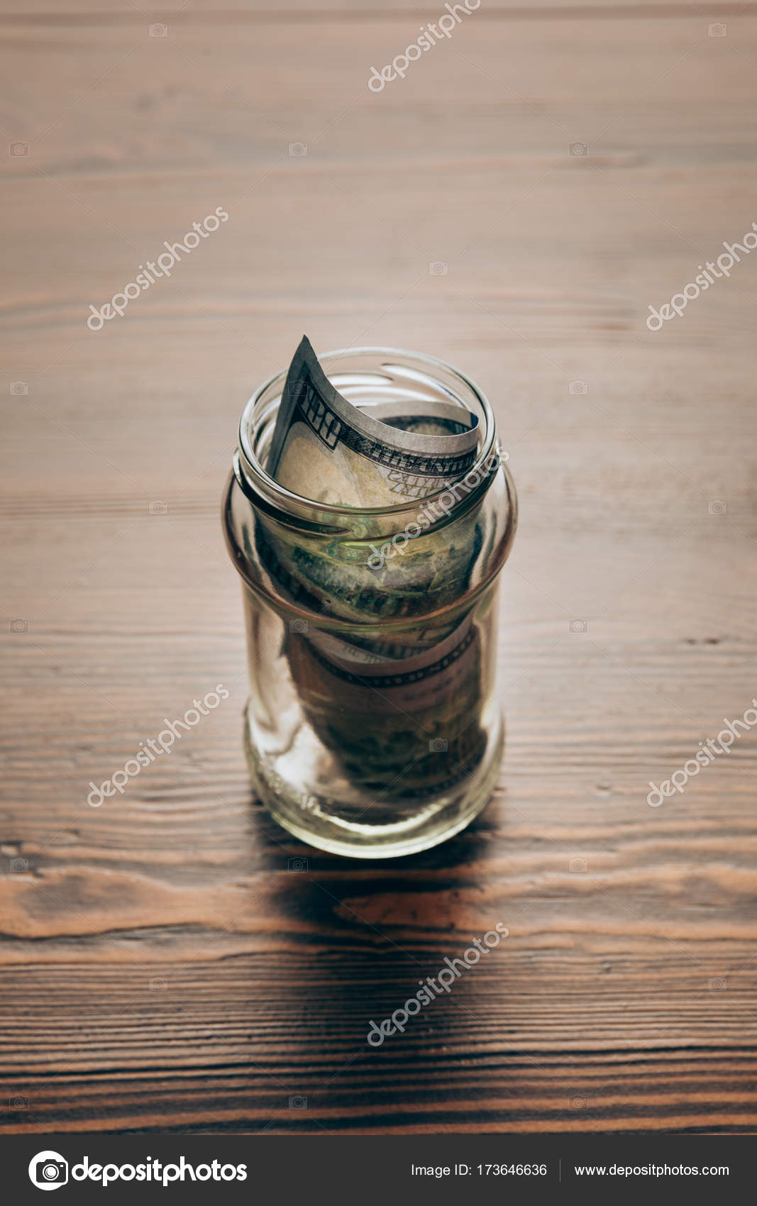 Glass jar with dollar banknotes — Stock Photo © AntonMatyukha #173646636