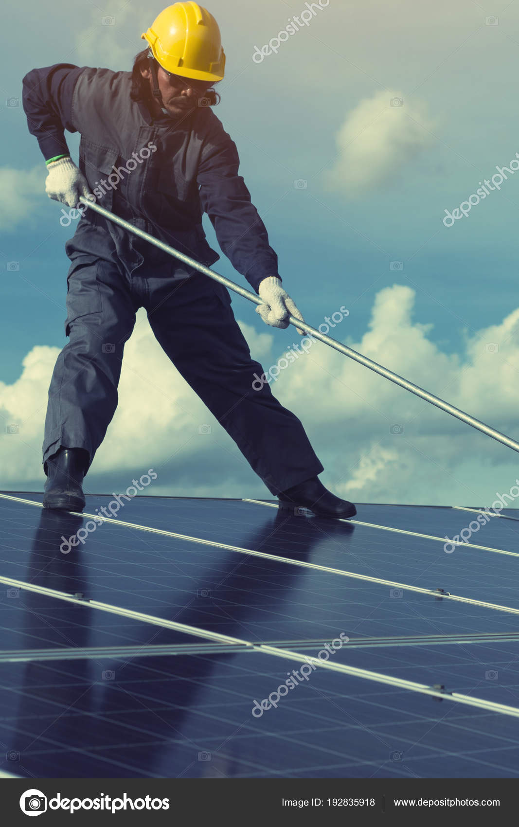Technician operating and cleaning solar panels at generating pow Stock ...