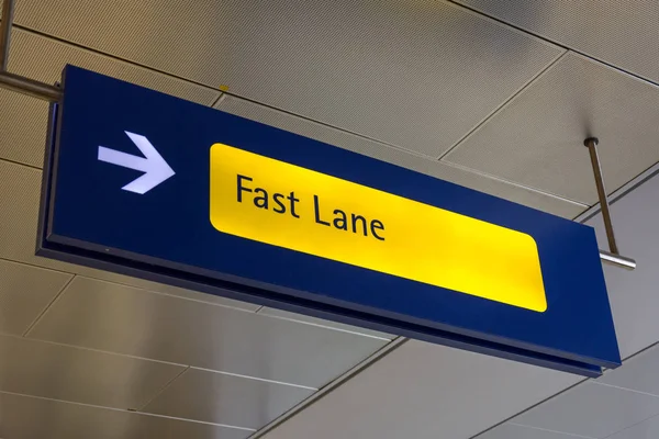 Fast Lane sign in blue and yellow at the airport - Stock Image - Everypixel