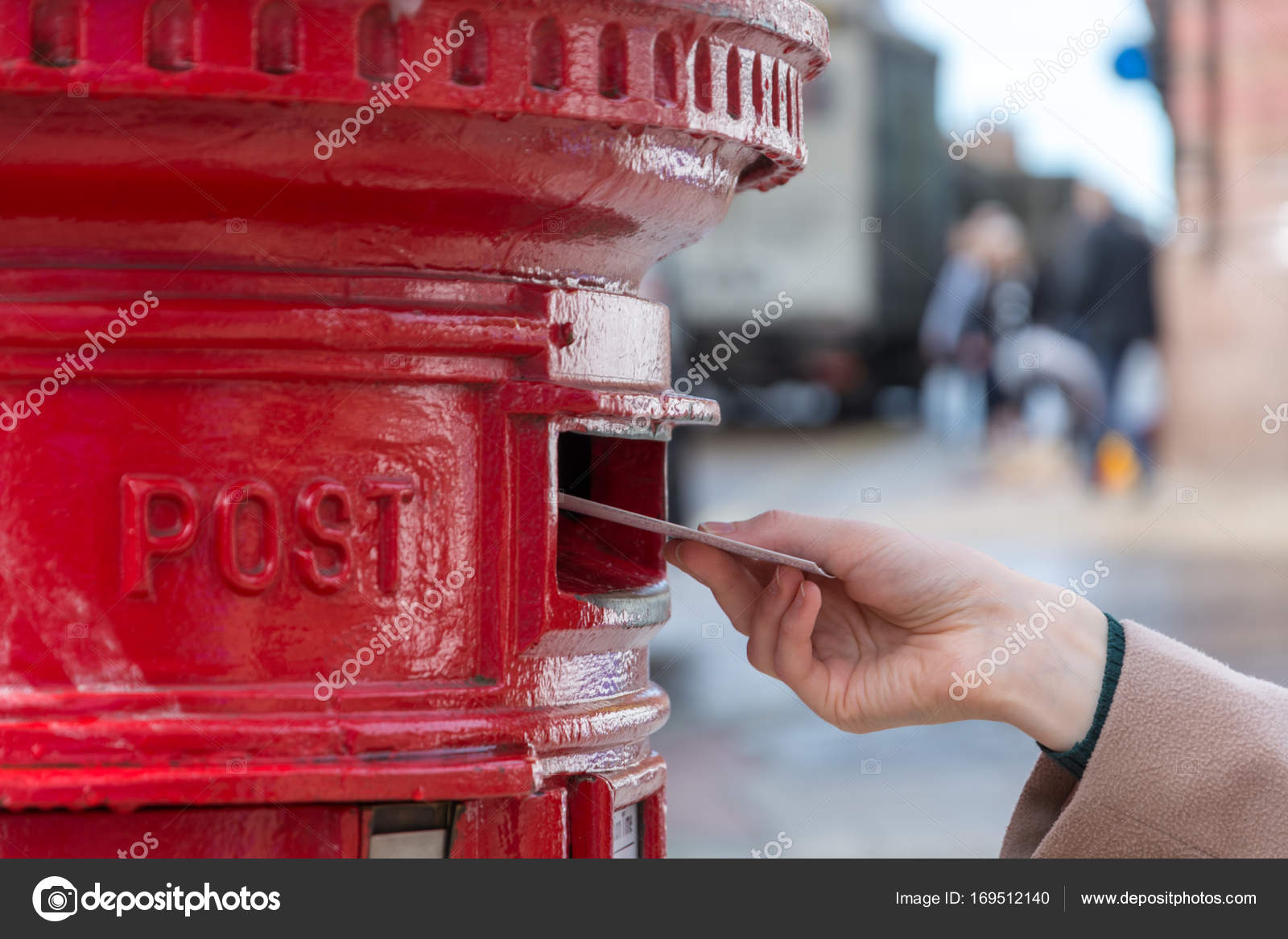 Throwing a letter in a red British post box Stock Photo by ©Asvolas ...