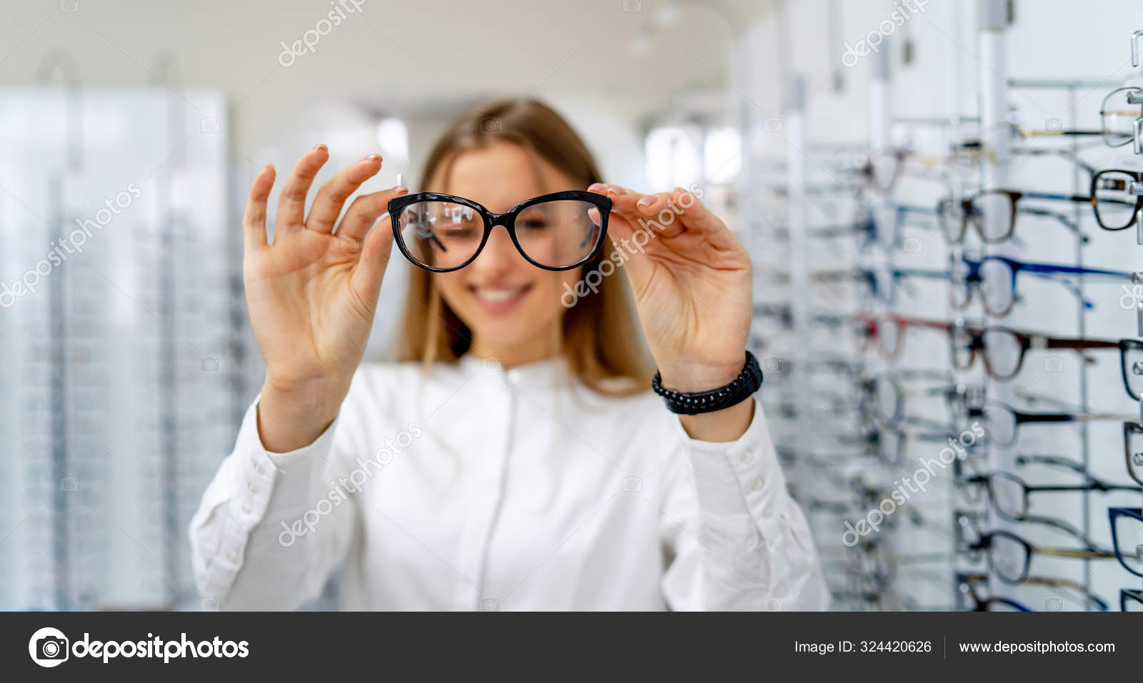 Eyeglasses closeup. Spectacles in womans hands. Presenting glasses ...